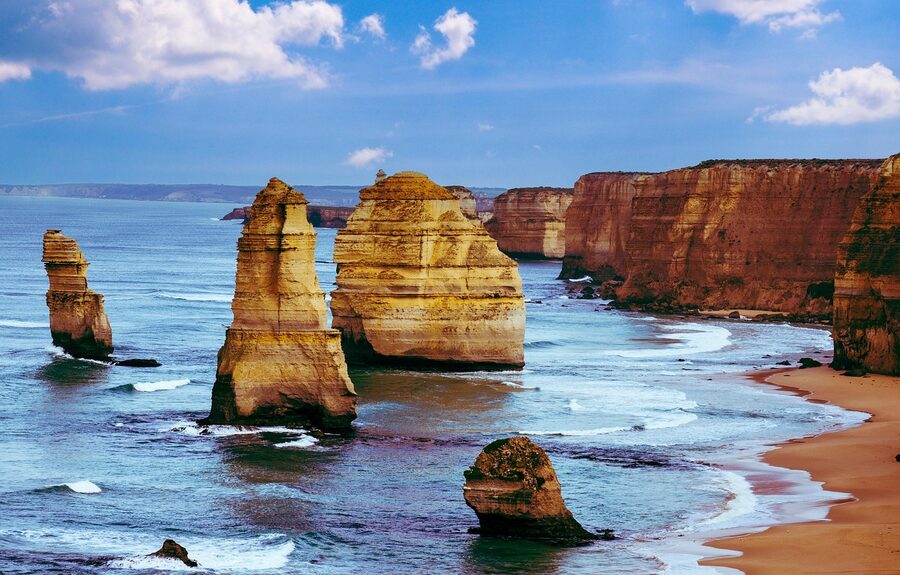 Coastal road along the Great Ocean Road with Twelve Apostles in the distance