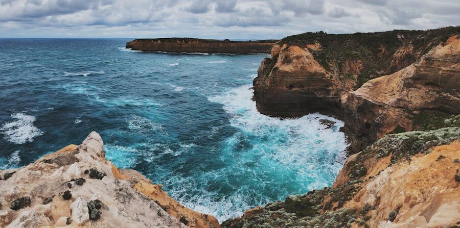 Dramatic coastal cliffs and ocean waves at Loch Ard Gorge