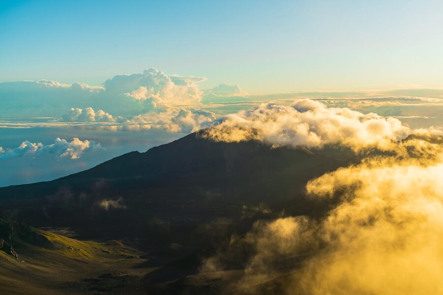 Aerial view of Haleakala Volcano at sunrise with clouds below