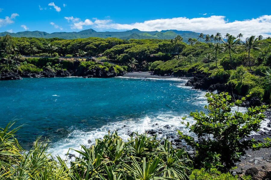 Lush green landscapes and blue waters of Hana Bay Maui