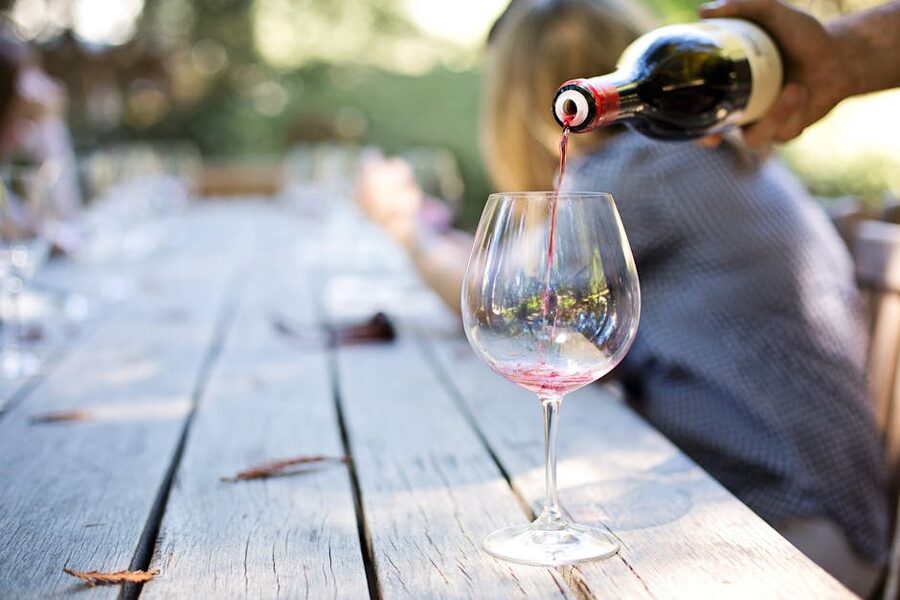 Wine being poured at an outdoor table
