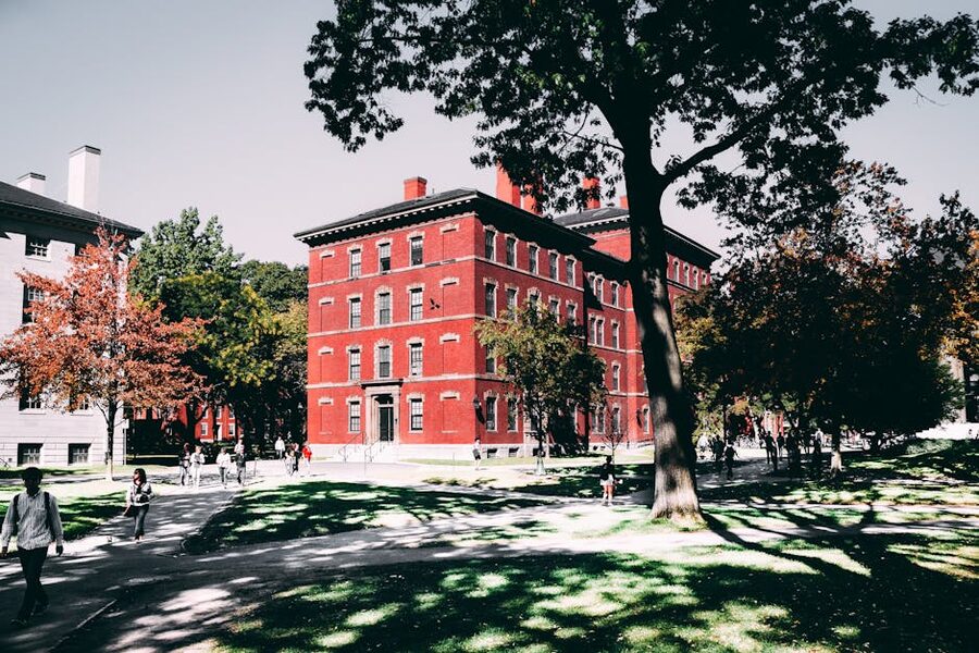 Historic red brick Harvard building surrounded by trees