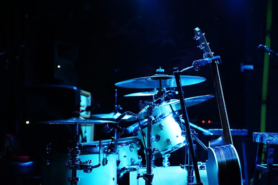 Drum kit set up on a show stage with microphones