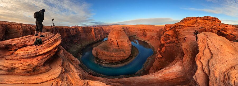 Photographer at Horseshoe Bend viewpoint capturing the canyon
