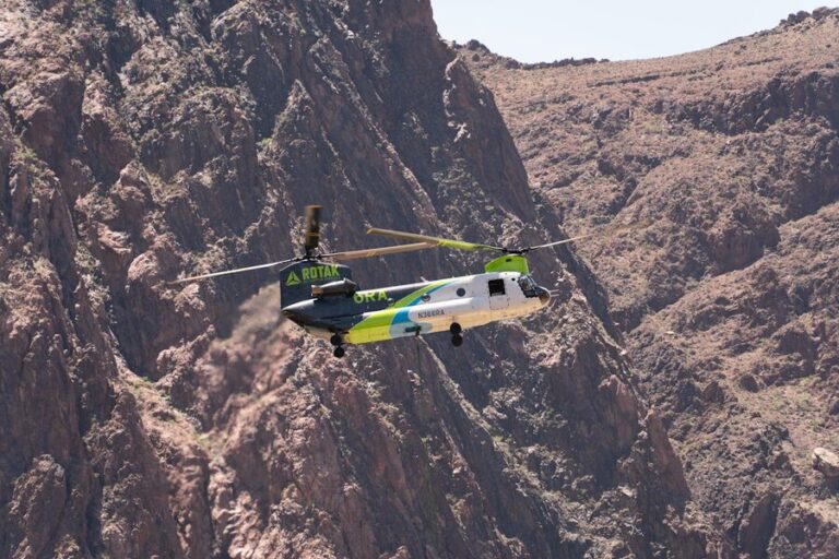 Helicopter flying over the rugged cliffs of the Grand Canyon