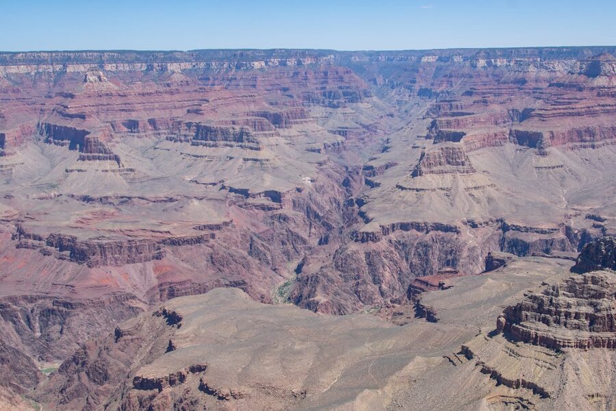 Aerial view of Grand Canyon layered rock formations from helicopter