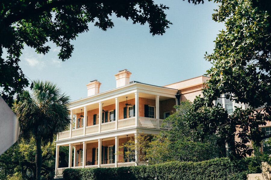 Historic Southern mansion in Savannah surrounded by lush greenery
