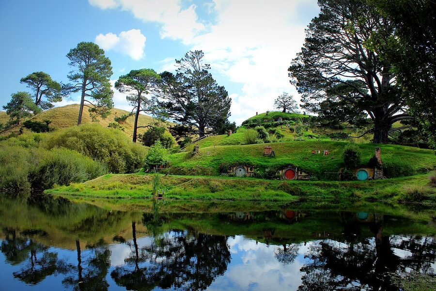 Hobbiton hobbit holes reflected in the lake