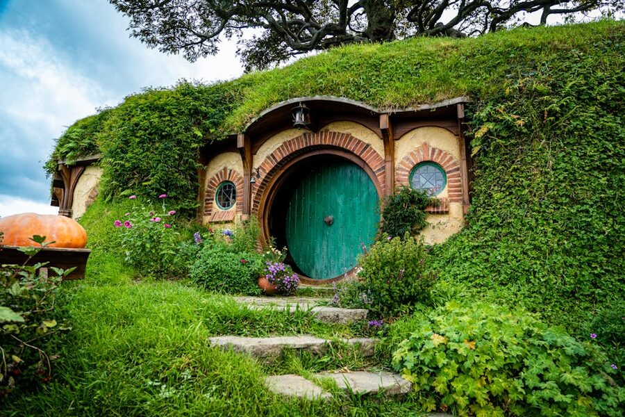 Hobbiton hobbit house with green roof and round door