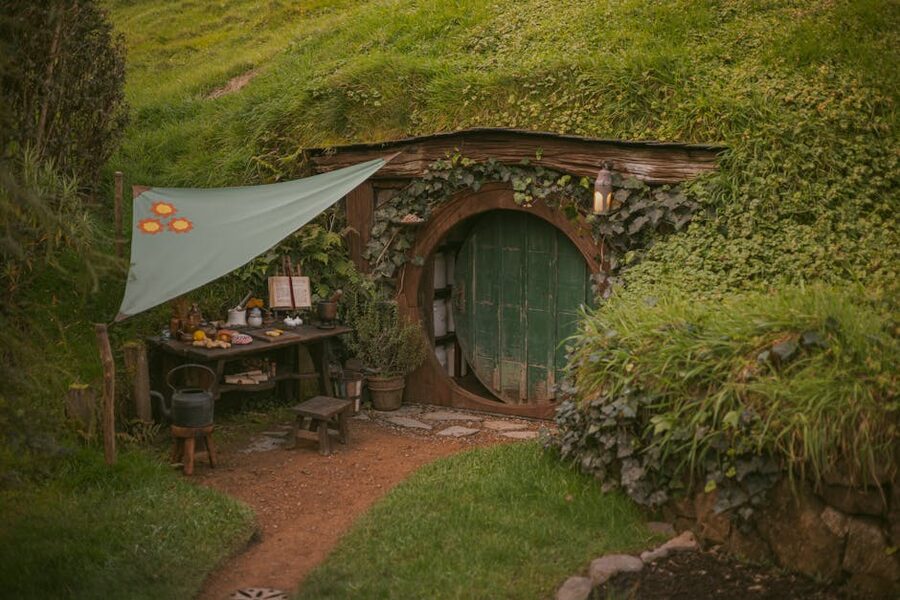 Hobbiton rustic hobbit house surrounded by greenery