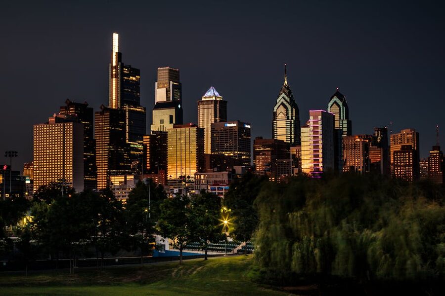 Philadelphia skyline illuminated at night from a park