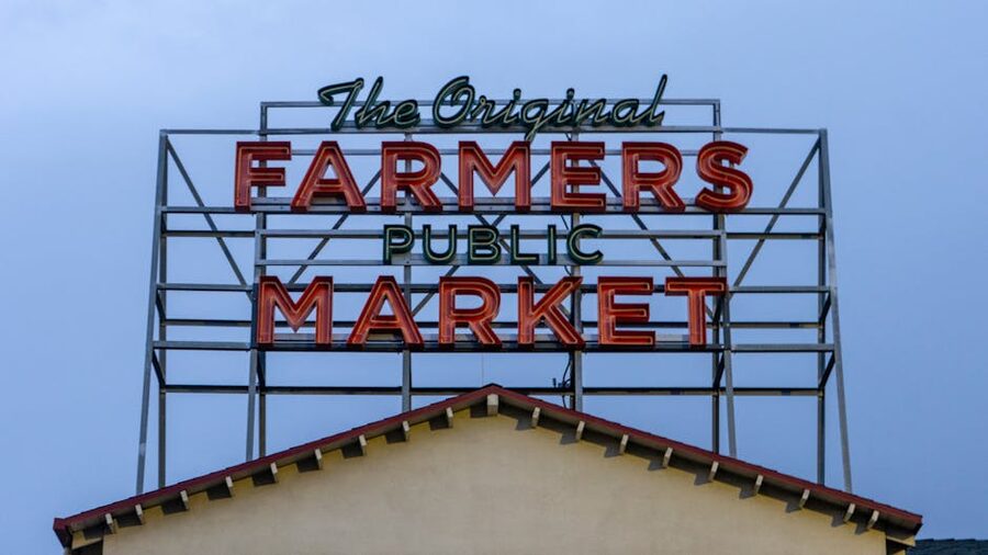 Original Farmers Market neon sign in Los Angeles at twilight