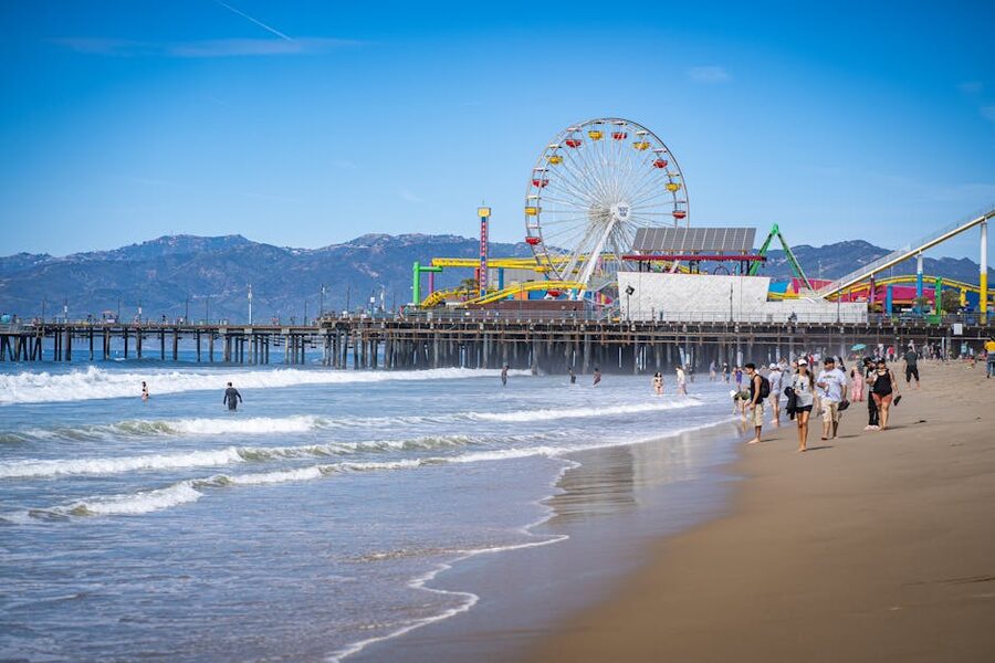 Santa Monica Pier with its Ferris wheel and people on the beach