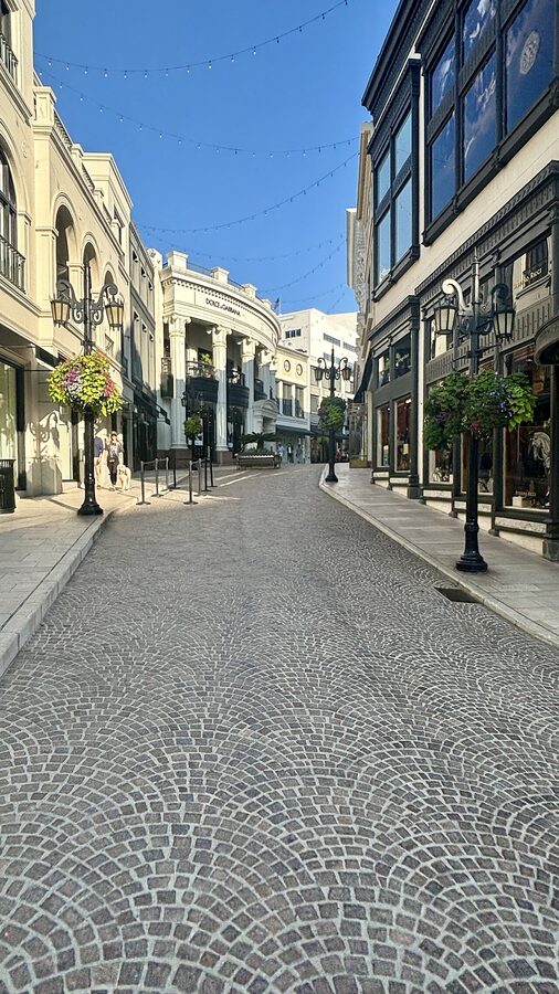Via Rodeo Drive with cobblestones, palm trees and luxury boutiques