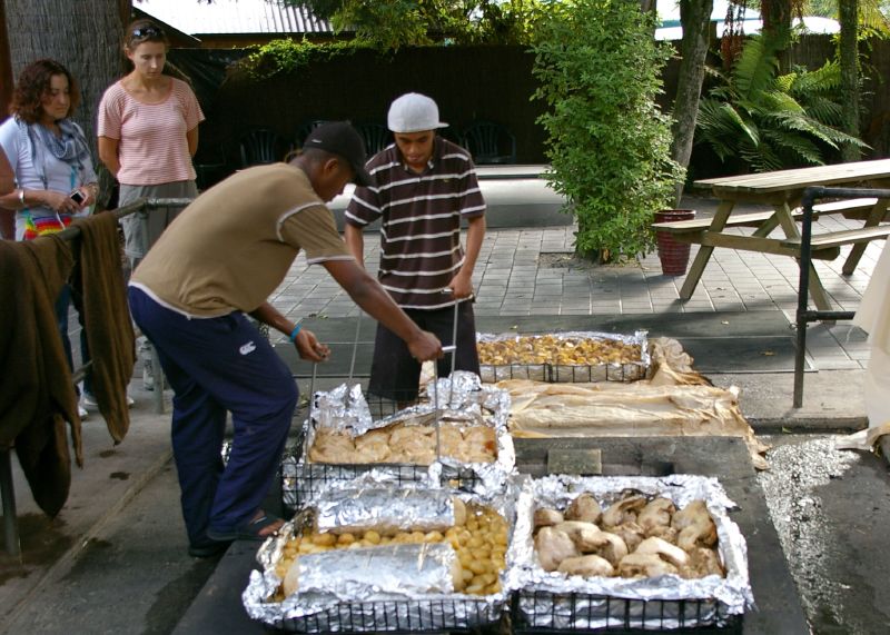 Hangi stones with cooked food being kept warm at Rotorua Maori experience