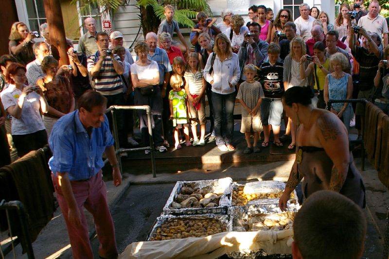 Hangi ceremonial unearthing of food cooked underground at a Rotorua Maori experience
