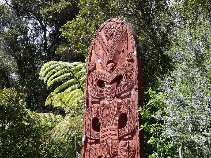 Carved Maori stake with traditional moko patterns Rotorua New Zealand