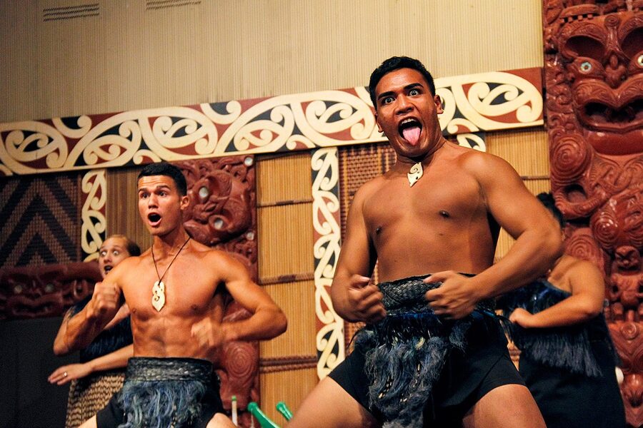 Maori dancers performing haka in traditional dress at cultural evening