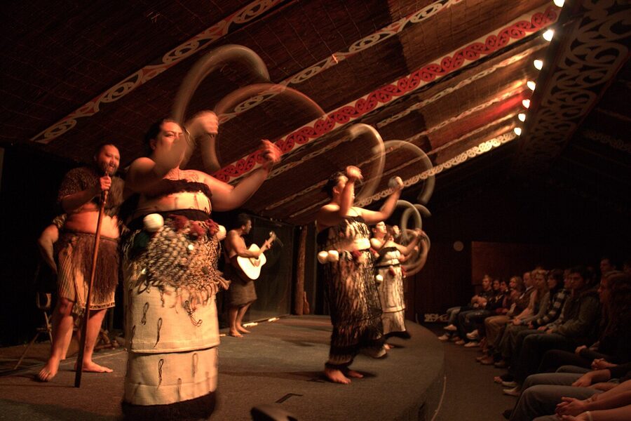 Maori poi demonstration with women spinning poi at cultural village Rotorua