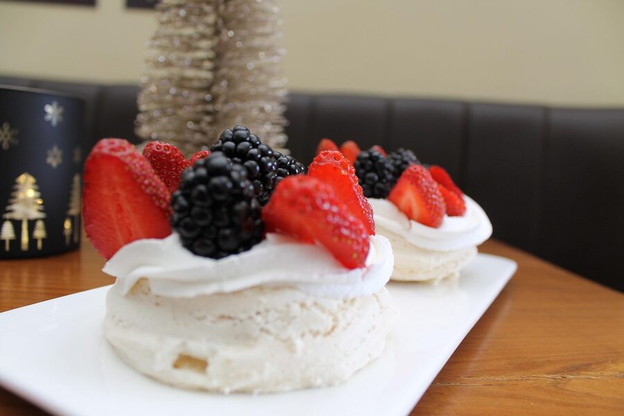 Pavlova dessert with cream and berries