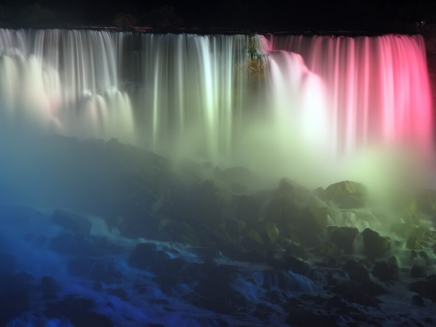 American Falls illuminated with multicolour lights at night Niagara
