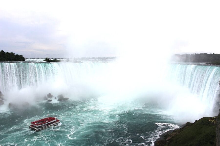 Aerial view of Niagara Falls with tour boat navigating below