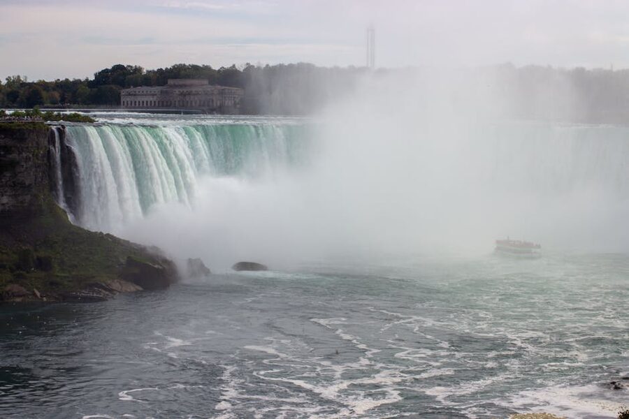 Wide view of Niagara Falls with mist from the Canadian side