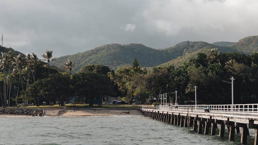 Coastal pier and lush mountains in Queensland Australia