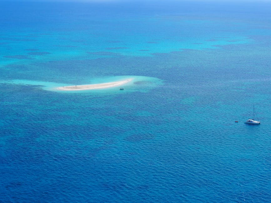 Boat near small island on the Great Barrier Reef from above