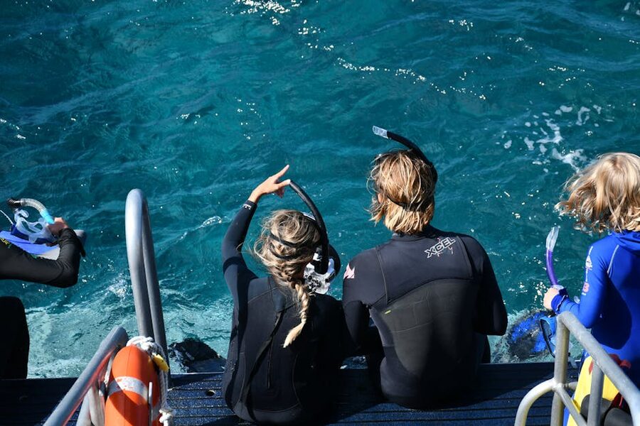 Snorkelers preparing on a platform in clear Australian waters