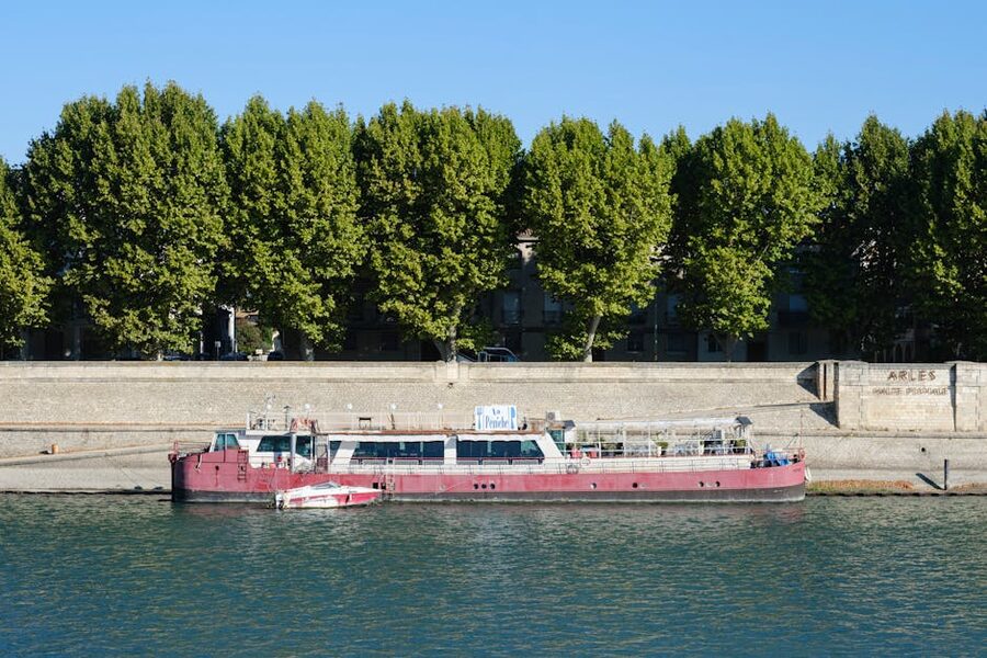 Rhone riverboat docked in Arles surrounded by trees