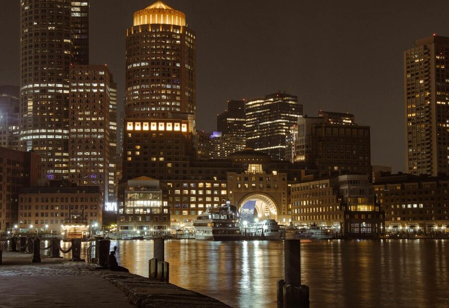 Boston illuminated skyline and harbor at night from Fan Pier Park