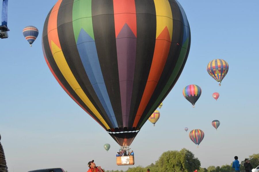 Hot air balloons floating over Teotihuacan at dawn