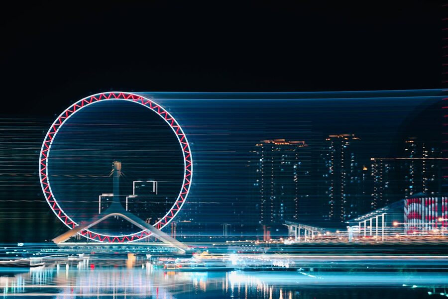 Ferris wheel illuminated in a city skyline at night