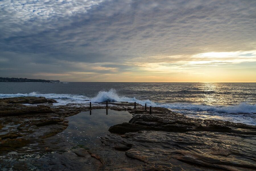 Sunrise over the rocks at Coogee Beach