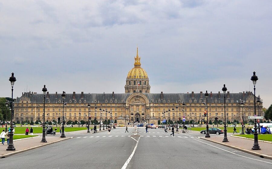 Visitors walking near Les Invalides golden dome on a cloudy Paris day