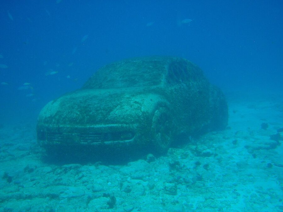 Coral-covered Volkswagen Beetle sculpture at the MUSA underwater museum off Isla Mujeres