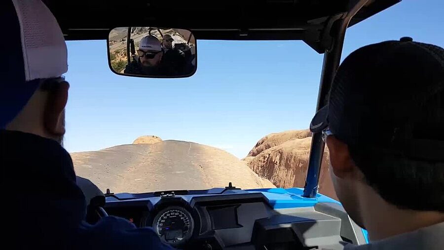 Jeep climbing a slickrock face on Hell's Revenge trail, Moab
