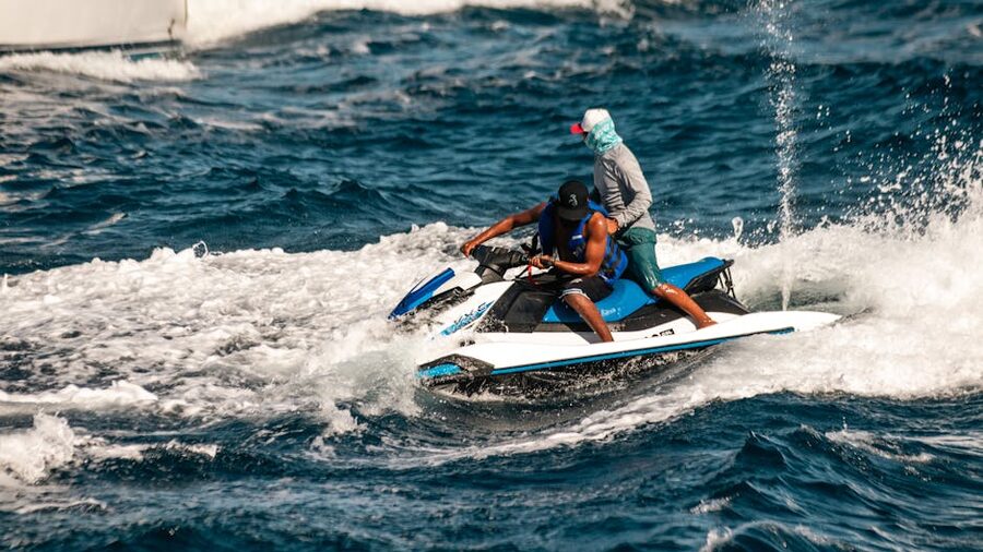 Two people riding a jet ski on the open ocean