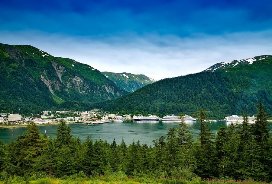Cruise ships docked in downtown Juneau Alaska with mountains behind
