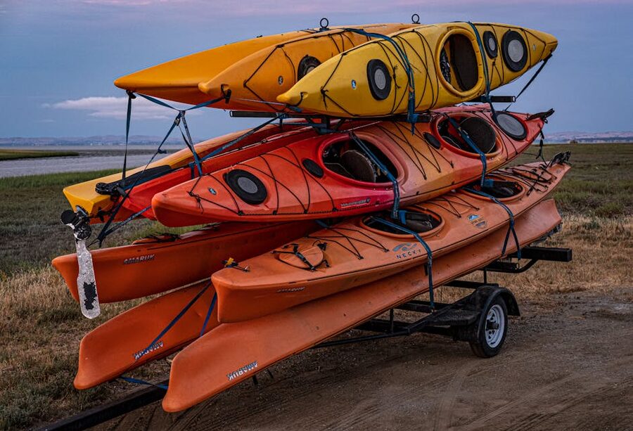 Colorful kayaks stacked on a trailer at a Florida launch