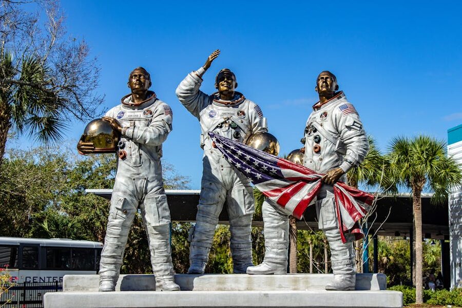 Statue of Apollo astronauts holding American flag at Kennedy Space Center