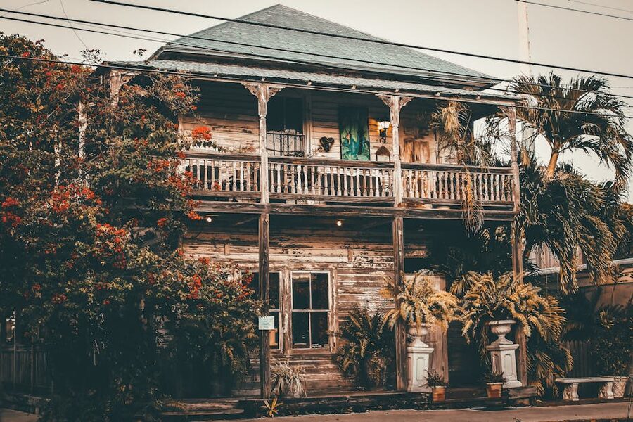 Rustic wooden Conch house surrounded by tropical foliage in Old Town Key West