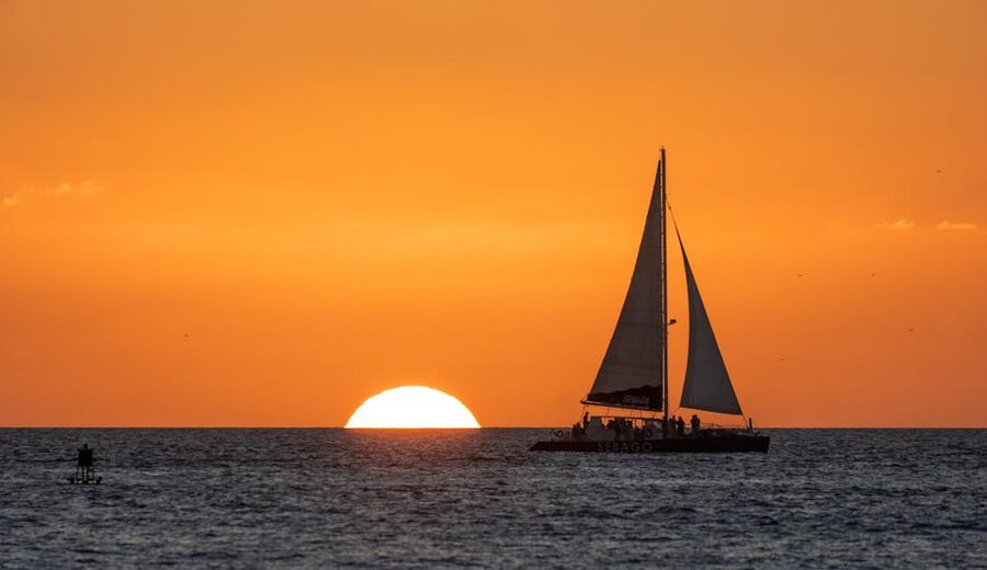 Sailboat over the ocean horizon at Key West sunset