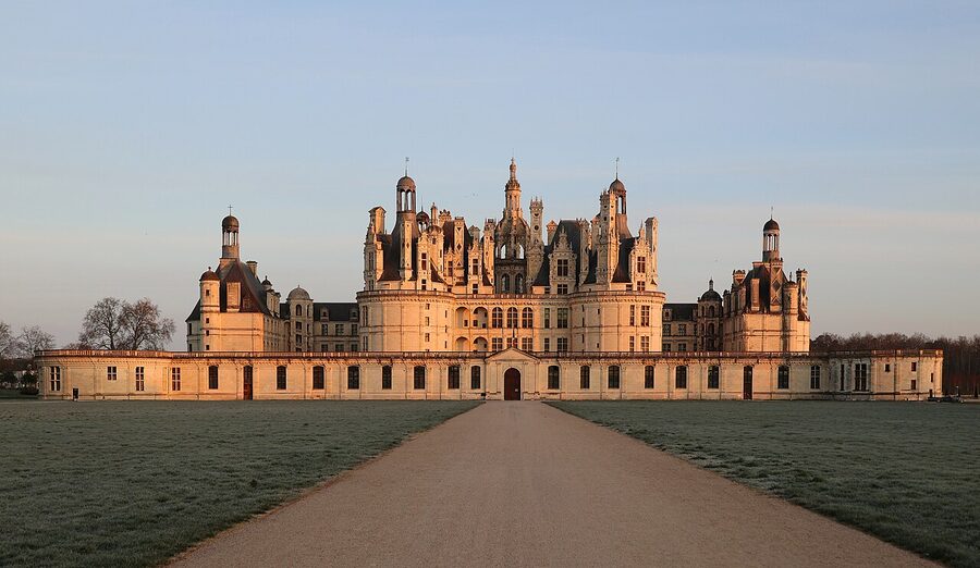 Chateau de Chambord at dawn with mist over the lawn