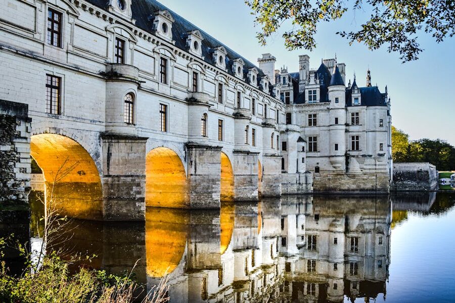 Chenonceau over the river with illuminated arches at dusk