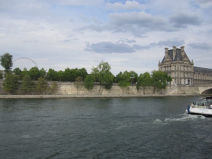 Louvre Museum facade from the Seine river