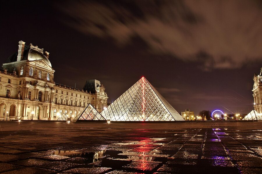 The Louvre pyramid illuminated in the evening