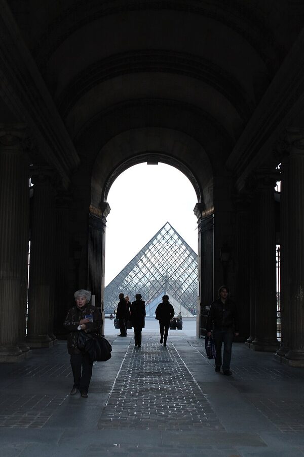 The Louvre pyramid framed by the Pavillon Sully arch