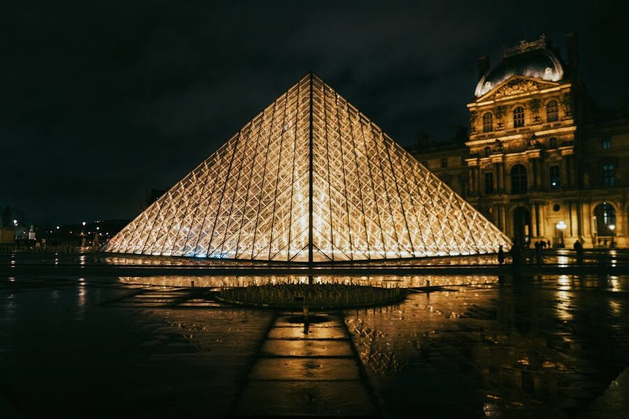 The Louvre pyramid glowing at night in Paris